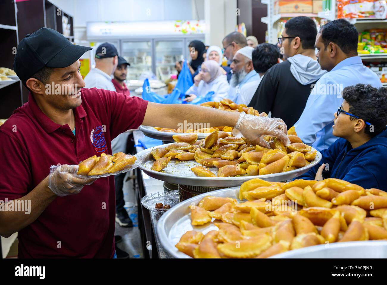 Ramadan 2025 In Doha The vendors selling traditional sweets serves a ...