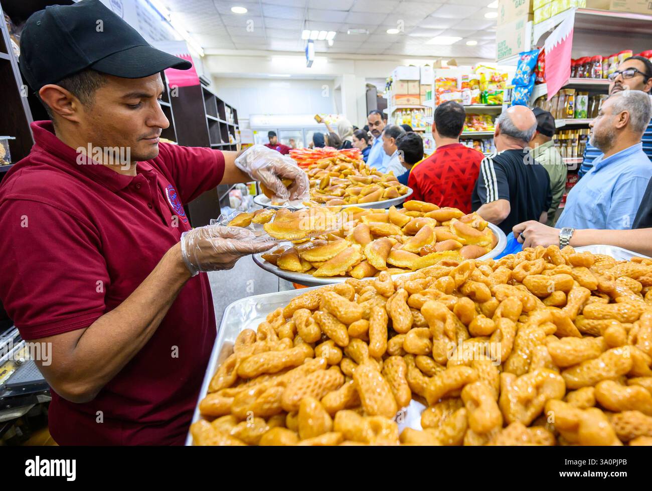 Ramadan 2025 In Doha The vendors selling traditional sweets serves a ...