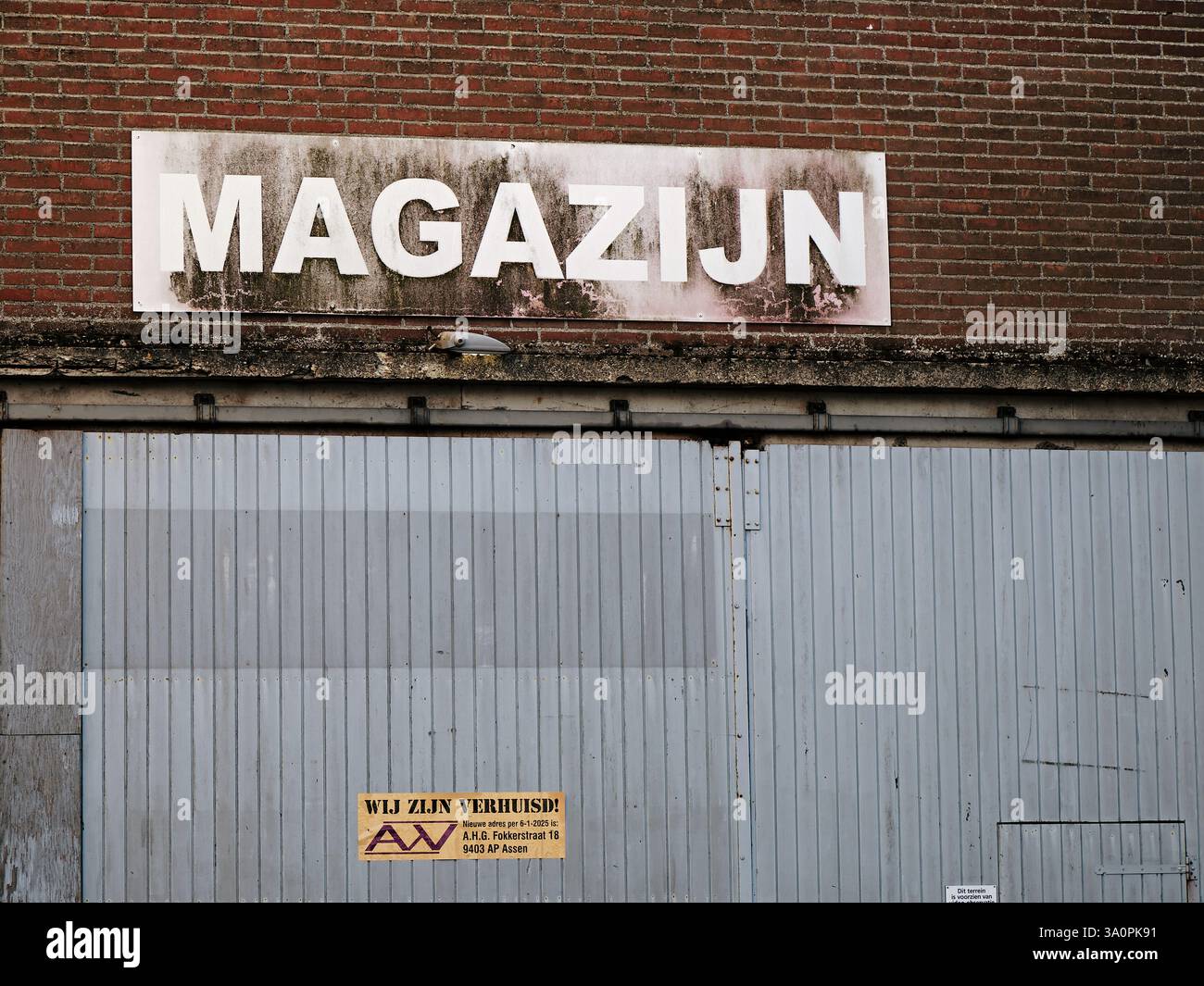 A historic grain silo with a red brick facade, weathered concrete ...