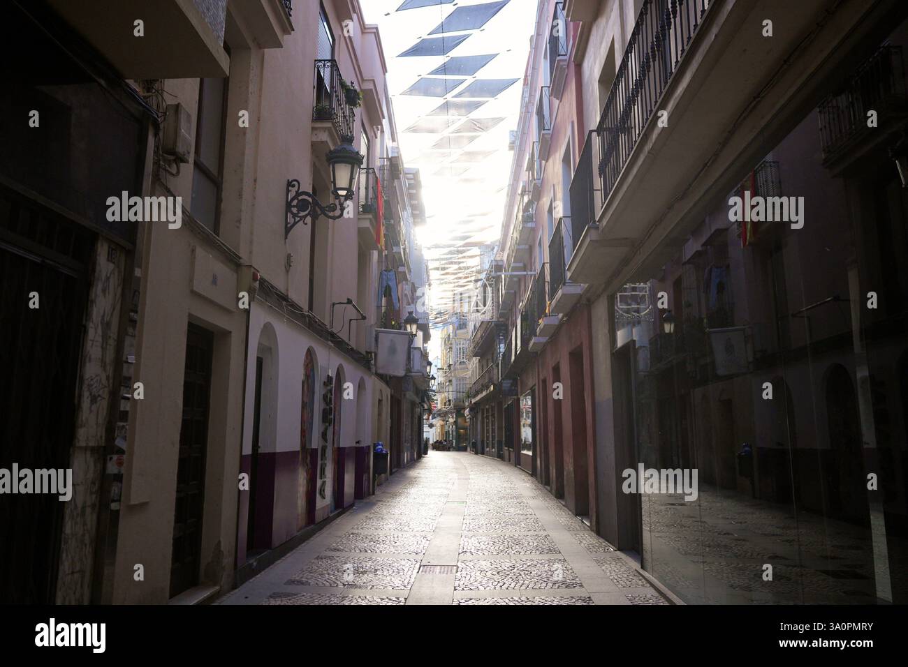 Peaceful pedestrian street in Badajoz, Spain, featuring sunshades, old ...