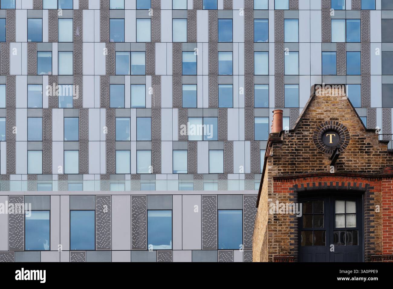 Old brick building facing a modern glass skyscraper Stock Photo - Alamy