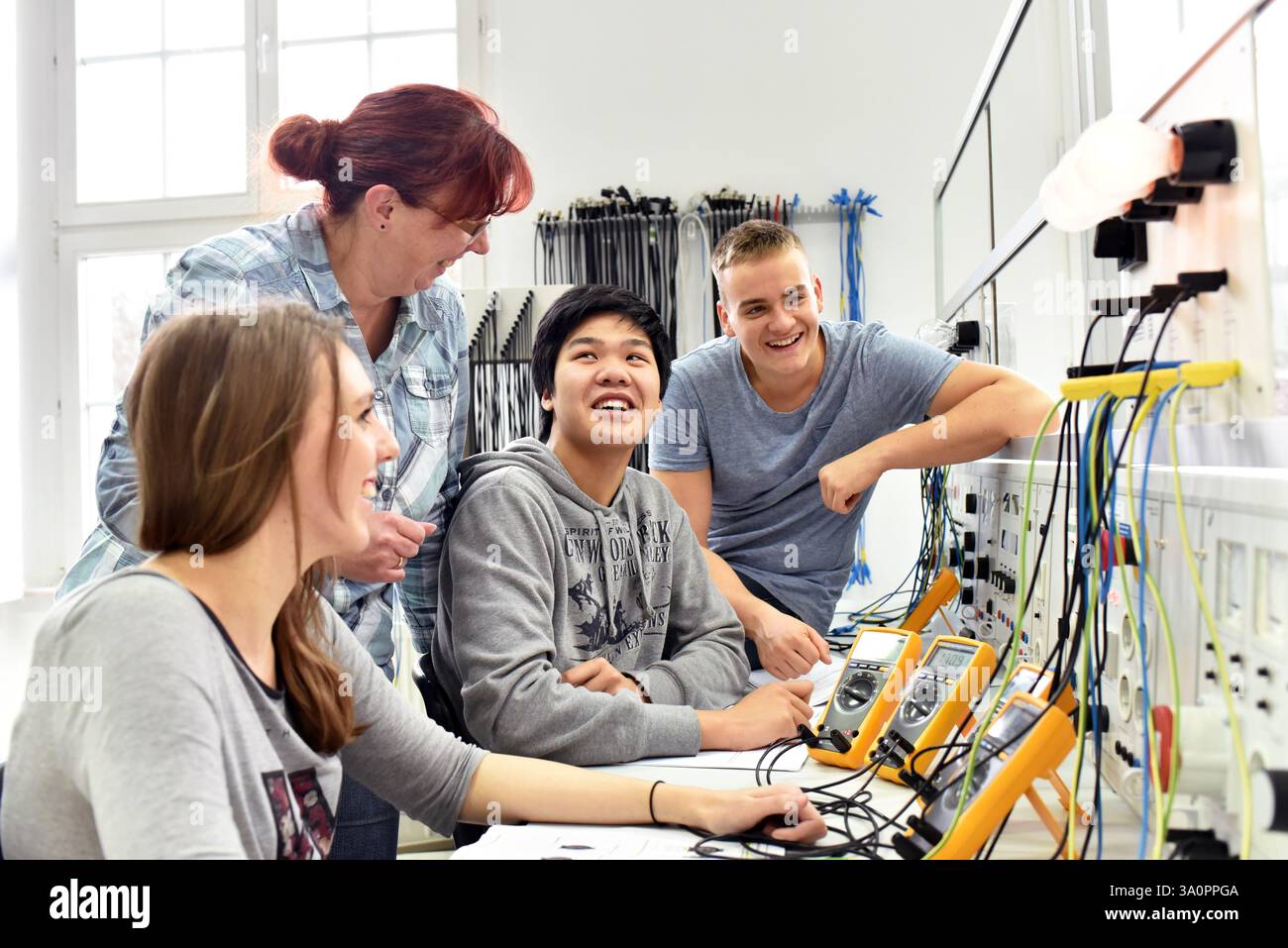 Group of young people in technical vocational training with teacher ...
