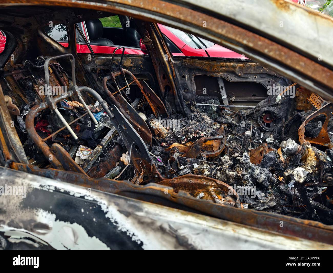 Charred remnants of a vehicle interior left behind after a devastating ...