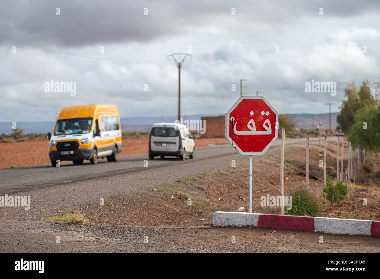 Marrakech, Morocco - February 19, 2025: Vehicles drive past a stop sign ...