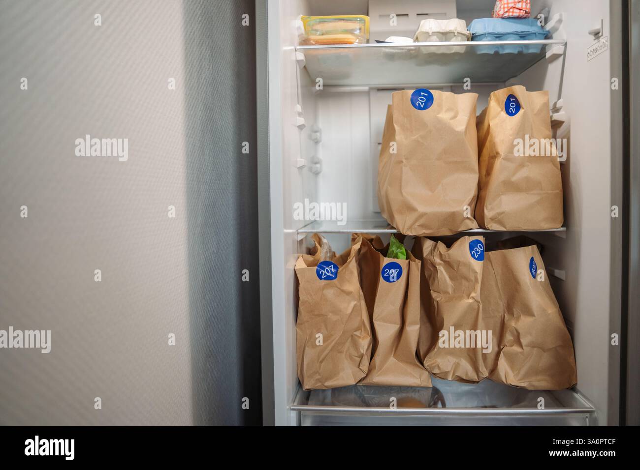 Groceries in brown paper bags in the fridge Stock Photo - Alamy
