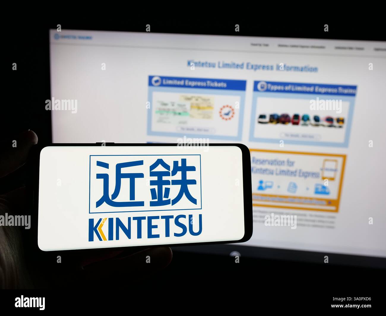 In this photo illustration, a person is holding a smartphone with the logo of Japanese company ...