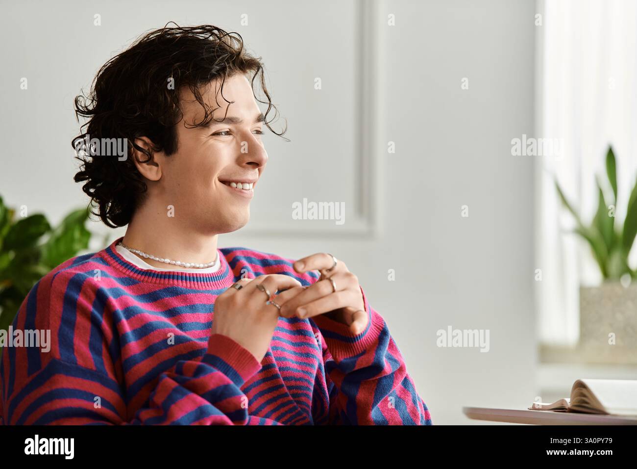 Curly-haired non-binary person enjoys a moment in their vibrant ...