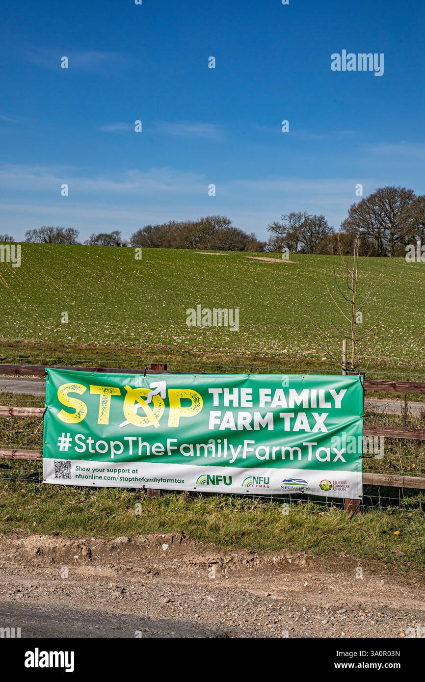 STOP THE FAMILY FARM TAX banner attached to a wooden fence with a ...