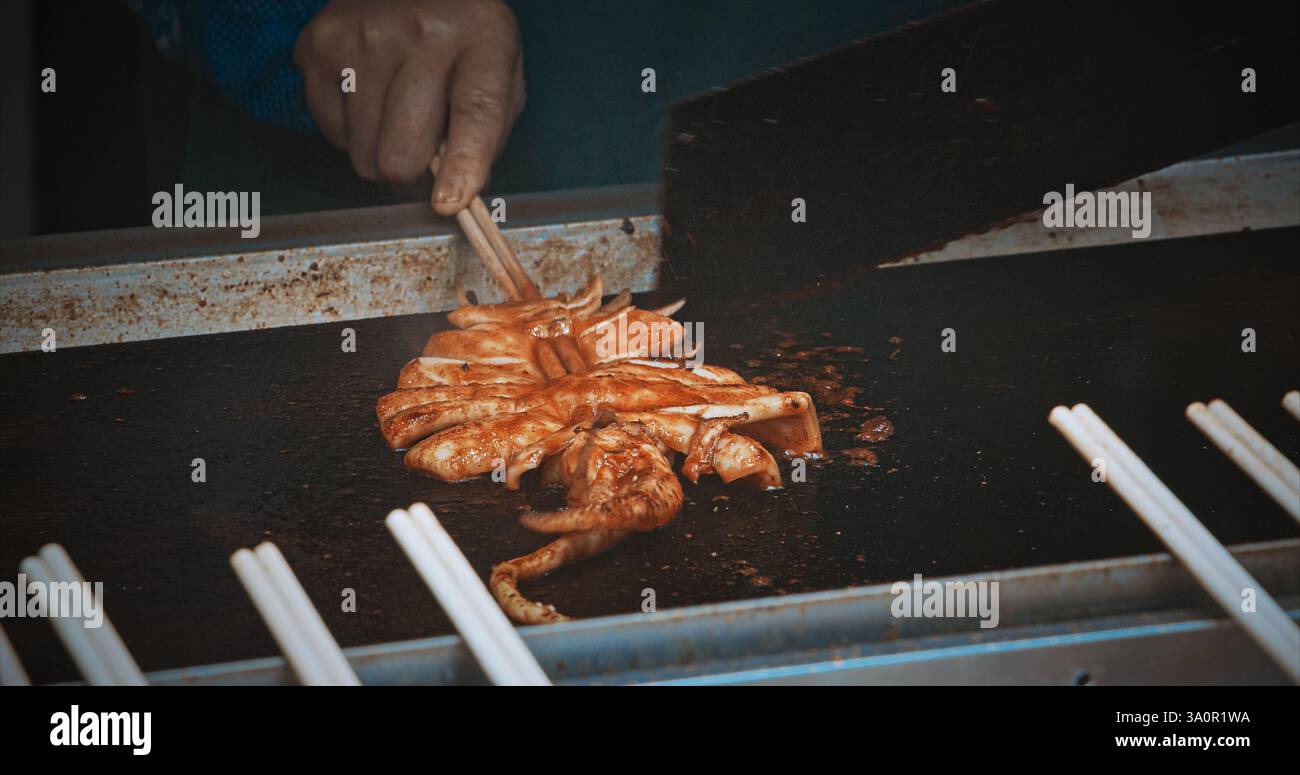 Chengdu, Sichuan, China. Man Fries Squid With Sauce and presses it to ...