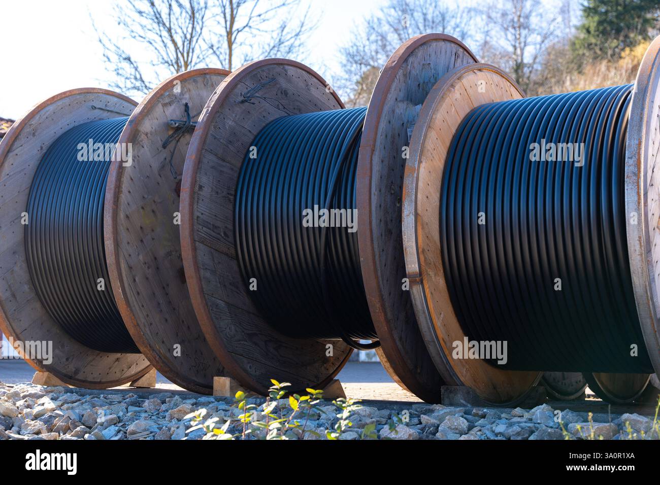 Large industrial reels with electrical cables are located at a ...
