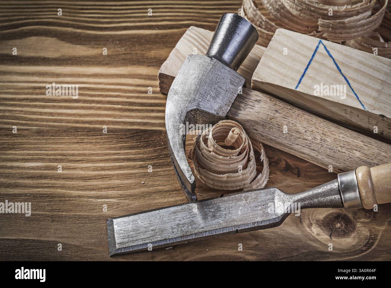 Claw hammer firmer chisel wooden studs shavings on vintage wood board ...