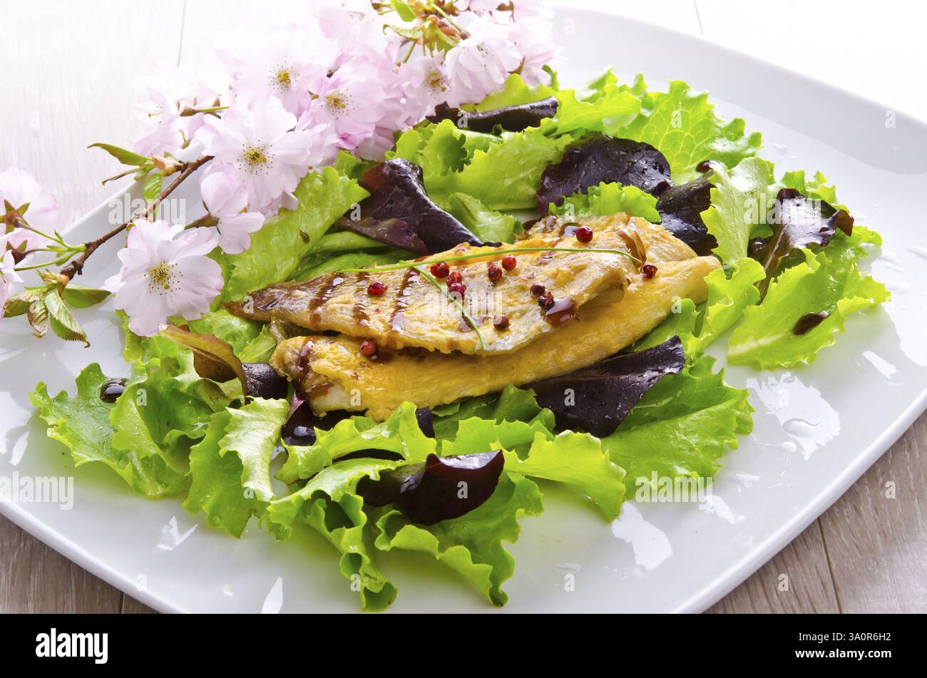 Roasted one fish with balsamic cream ones Stock Photo - Alamy