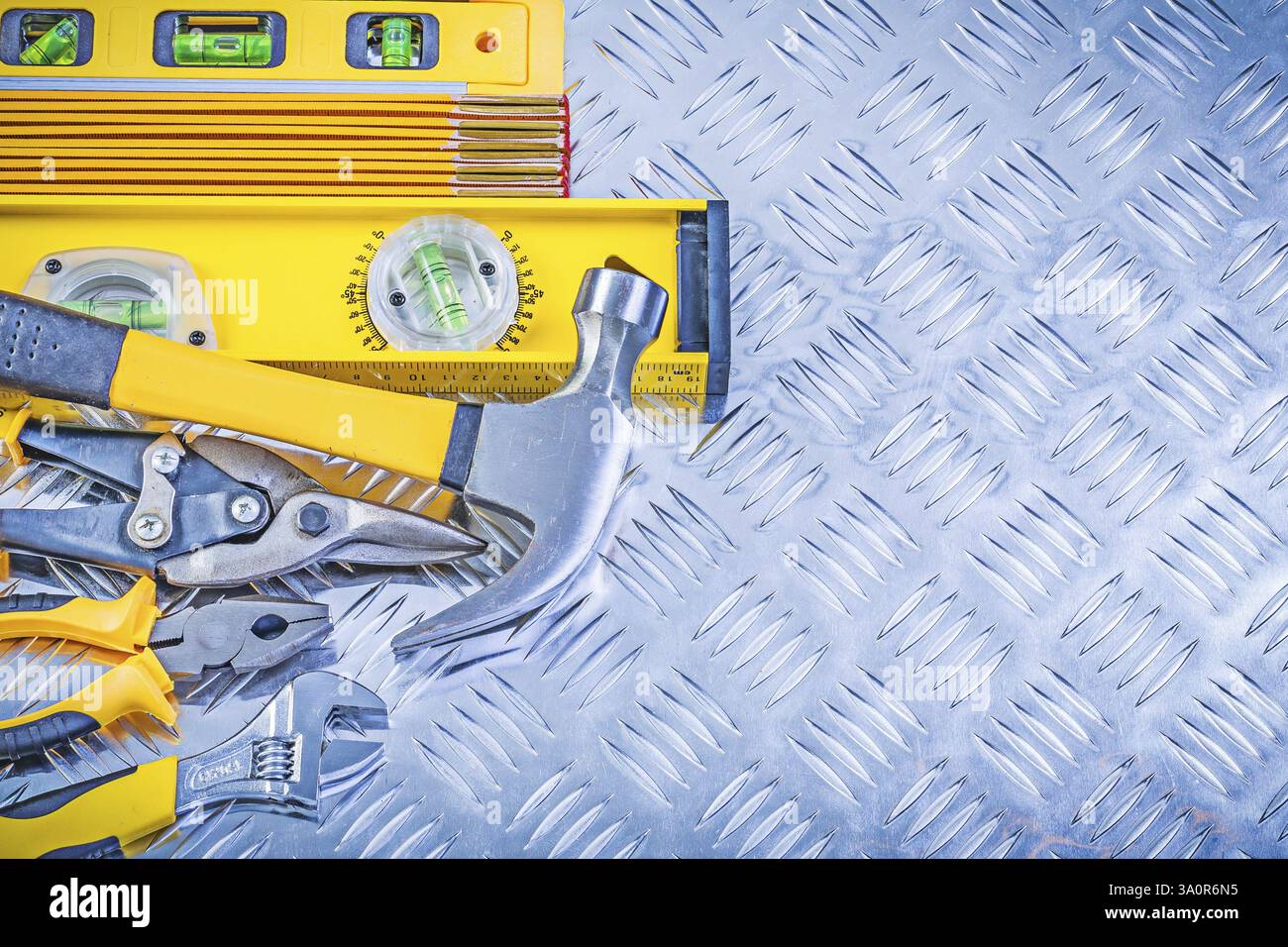 Collection of construction tooling on corrugated metal background ...