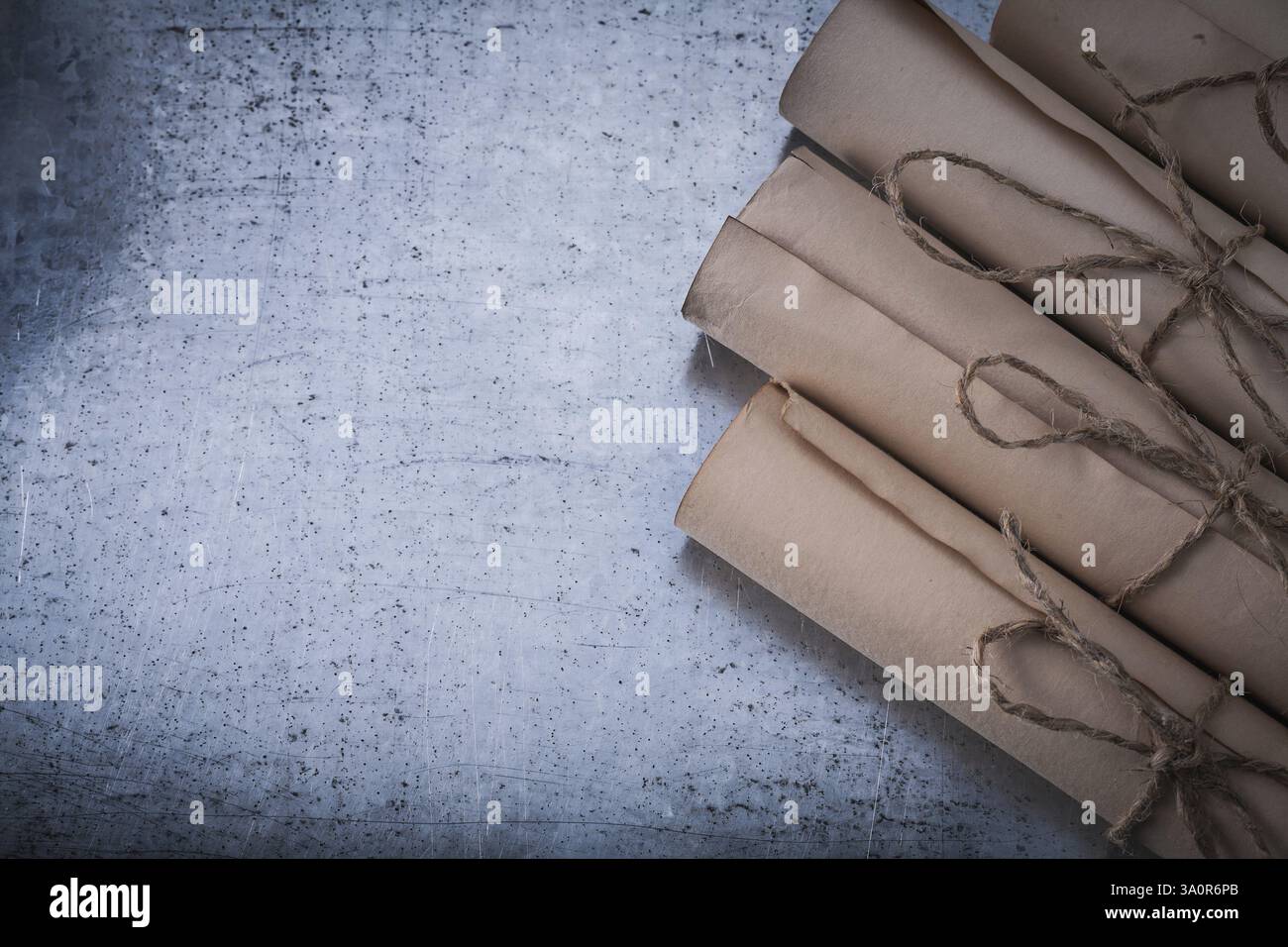 Collection of vintage paper rolls on scratched metallic background ...