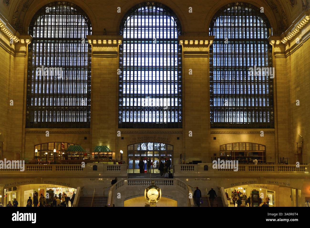 Large windows illuminate the station concourse, people move through the ...