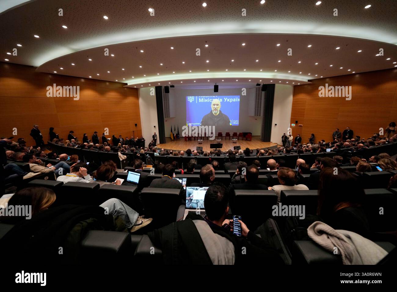 Ukraine's Prime Minister Denys Shmyhal, is seen on the scree in a video ...