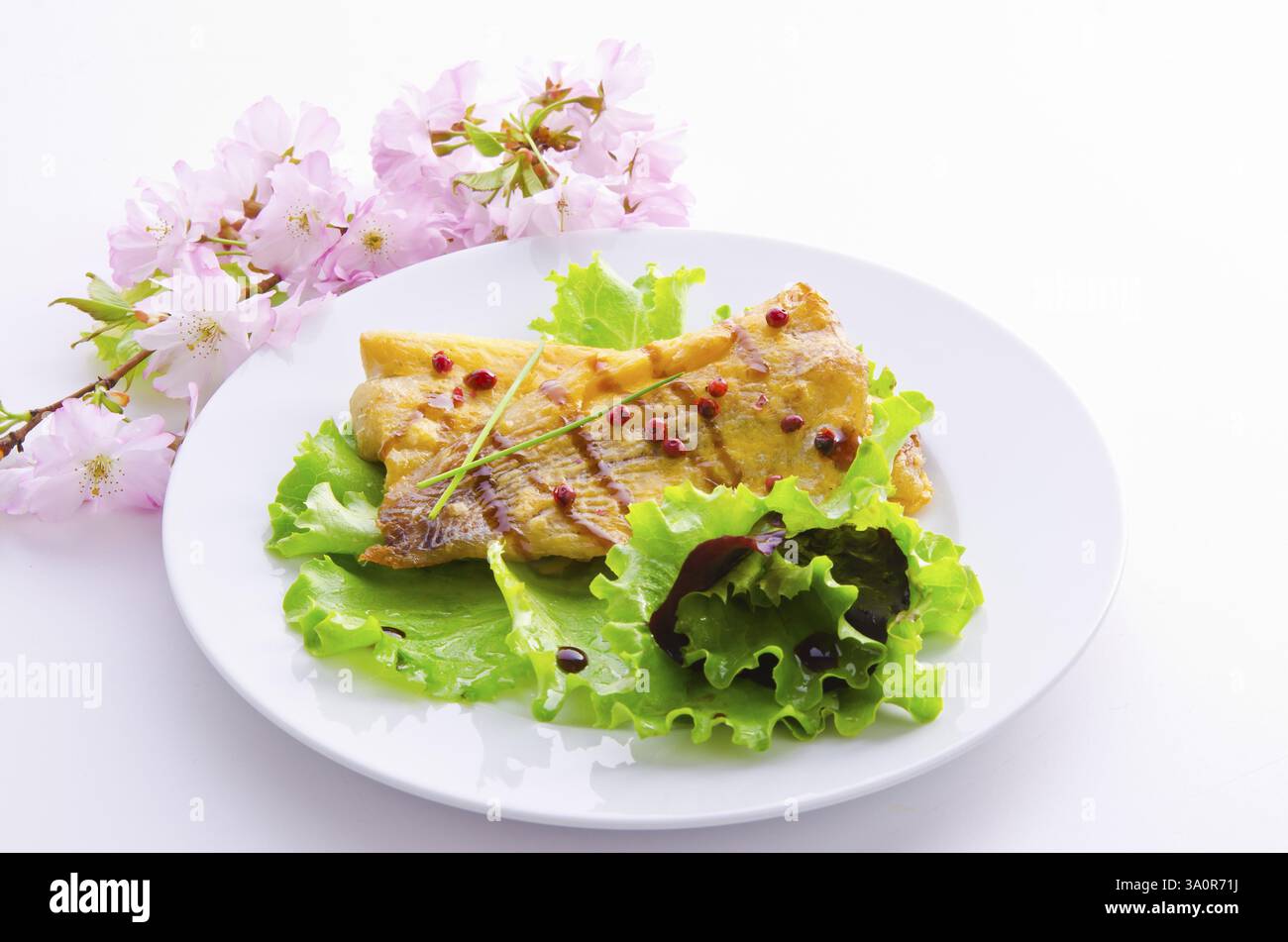 Roasted one fish with balsamic cream ones Stock Photo - Alamy