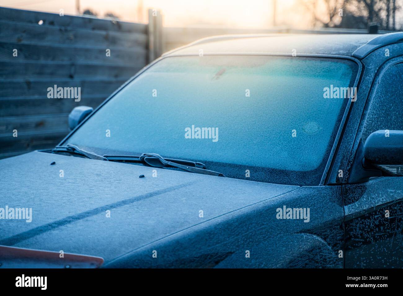 Black car covered in frost on an early winter morning. Frosty morning ...