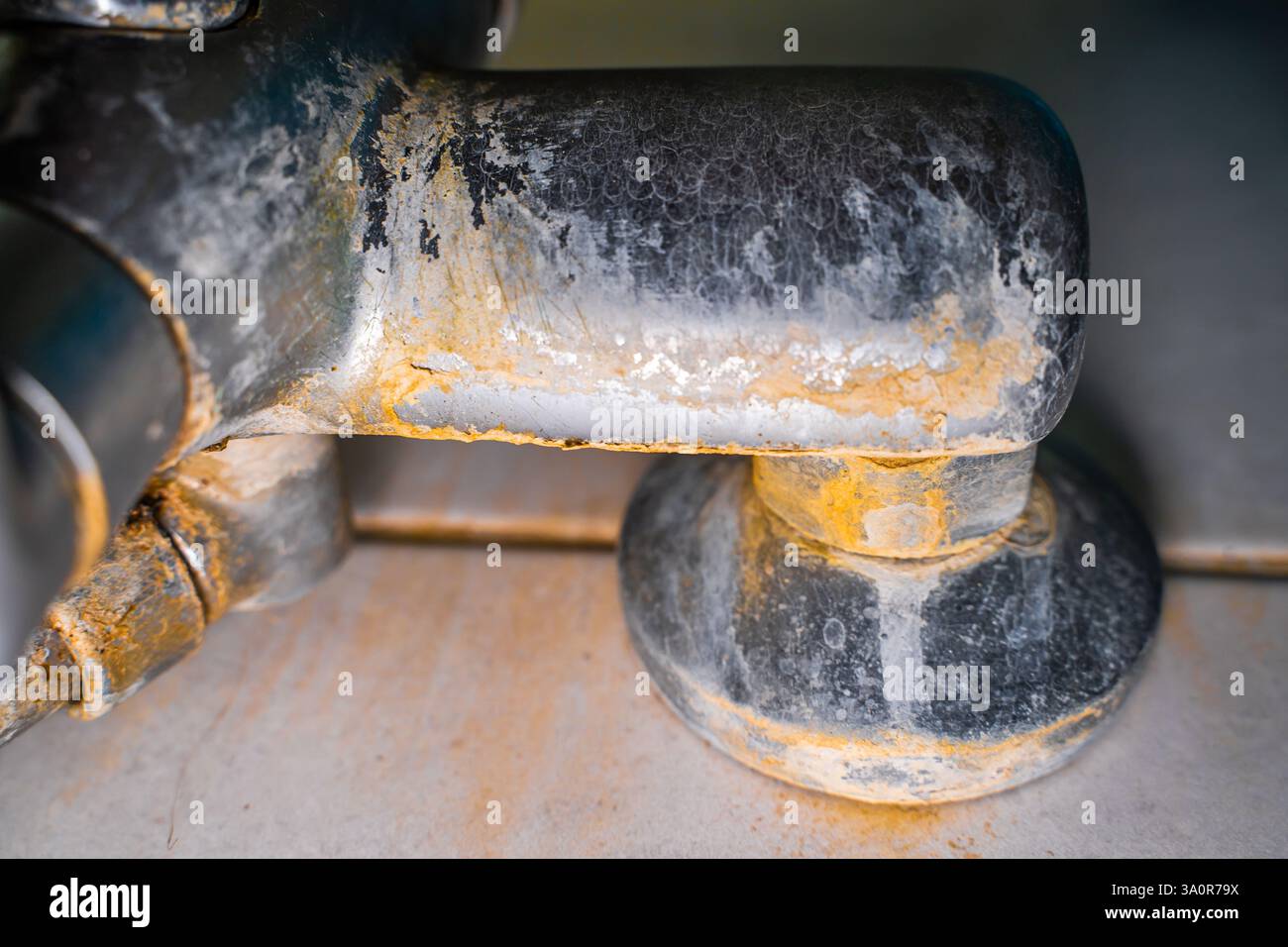 Bathroom faucet covered in scale and corrosion close-up, bottom view ...