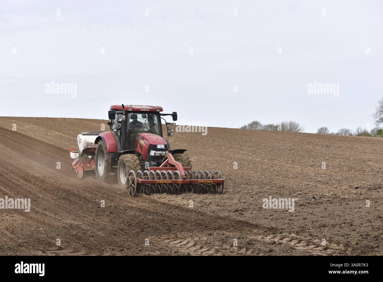 Tractor with front implement in the field Stock Photo - Alamy