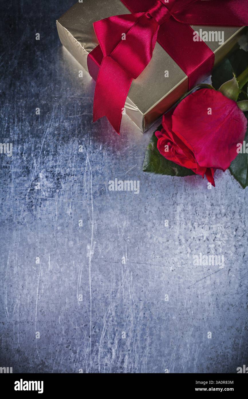 Composition of natural rose present box on scratched metallic ...