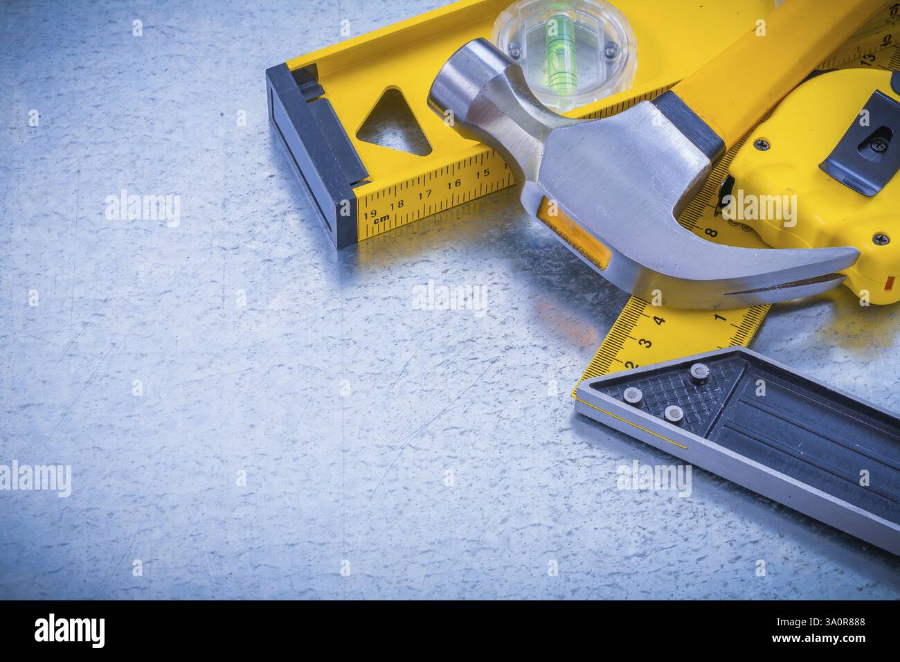 Claw hammer tape line construction level square ruler on metallic ...