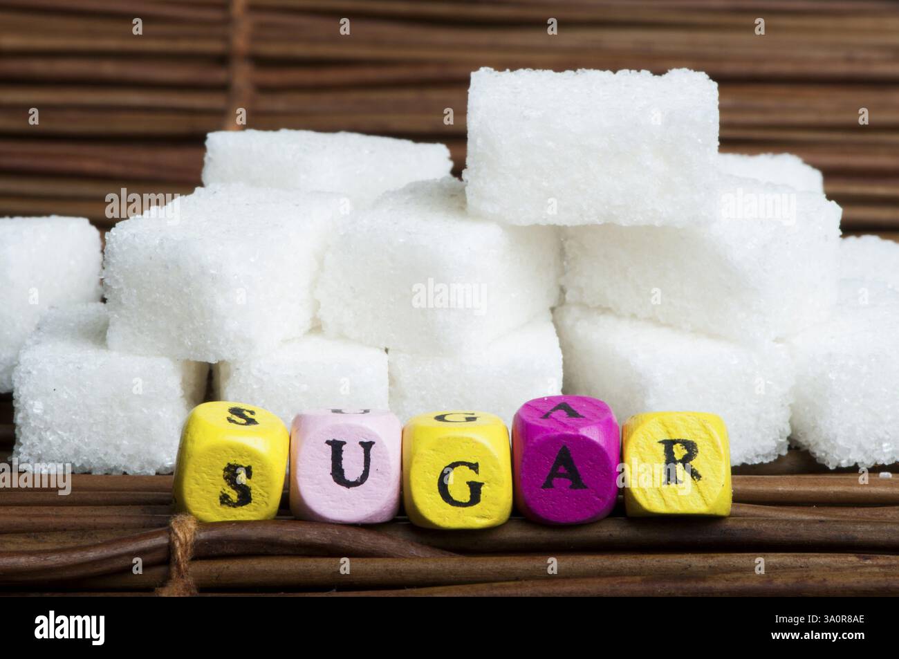 Sugar lumps and word sugar. Multicoloured cubes Stock Photo - Alamy