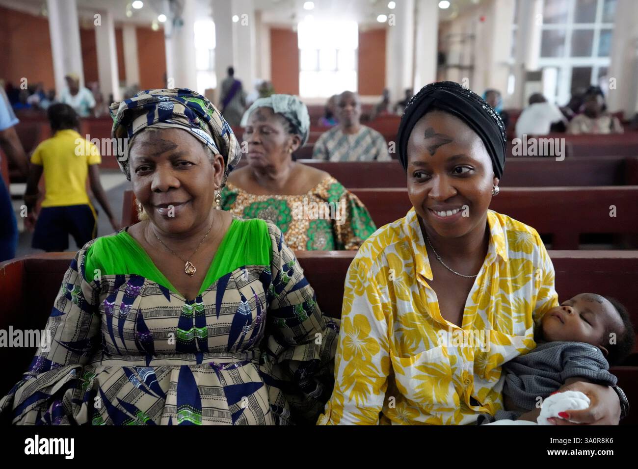 Catholic faithful with the sign of the cross in ash made on there ...