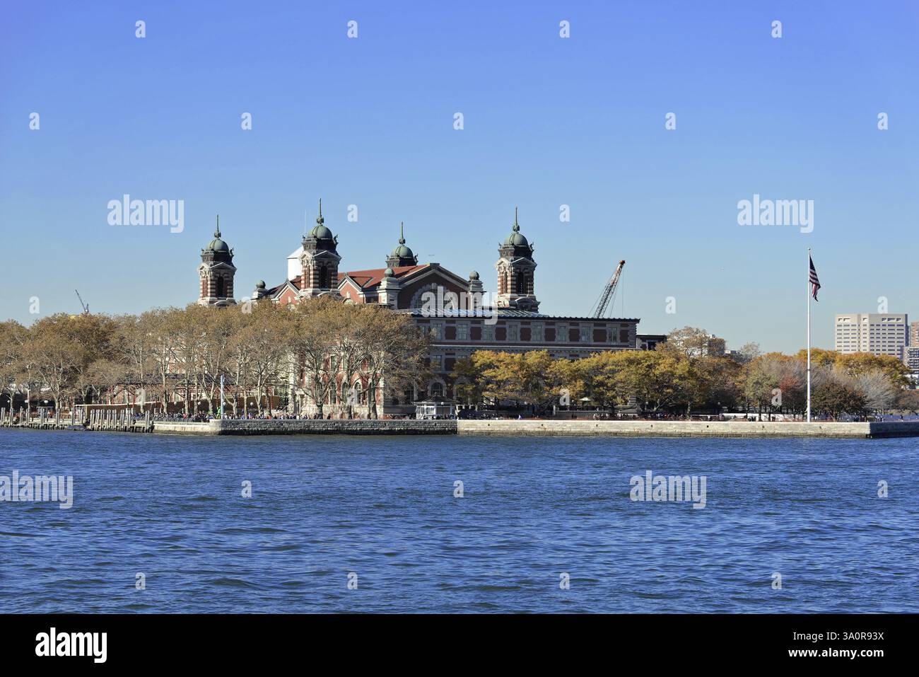 Ellis Island with historic buildings and an American flag over the ...