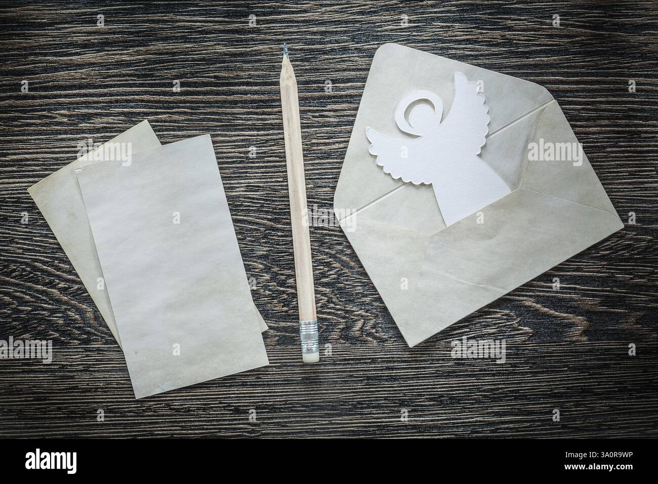 Composition of vintage envelope paper angel pencil on black board Stock ...