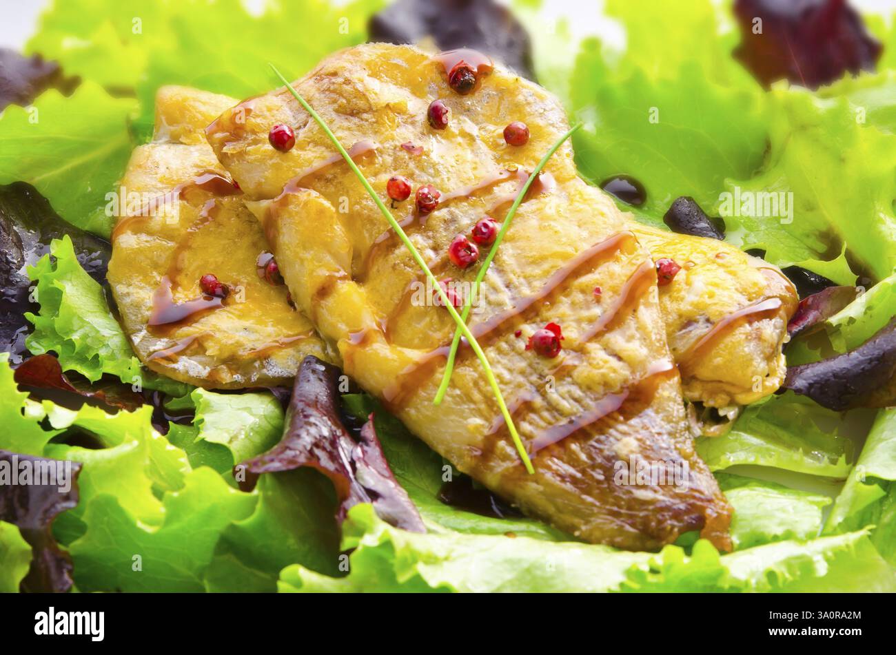 Roasted one fish with balsamic cream ones Stock Photo - Alamy