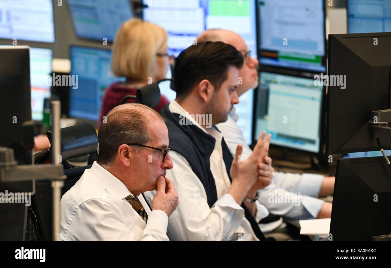 05 March 2025, Hesse, Frankfurt/Main: Stock market traders watch their ...