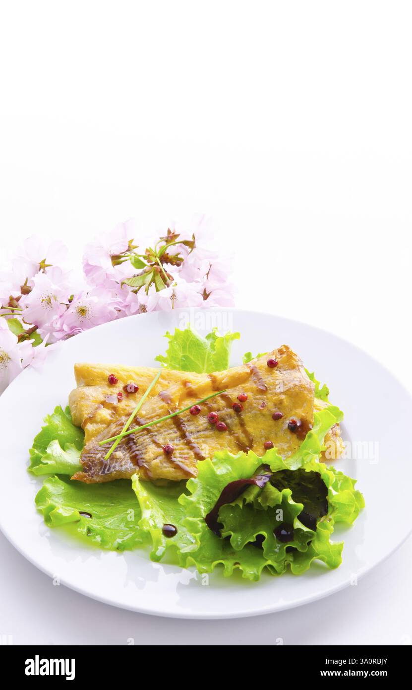 Roasted one fish with balsamic cream ones Stock Photo - Alamy