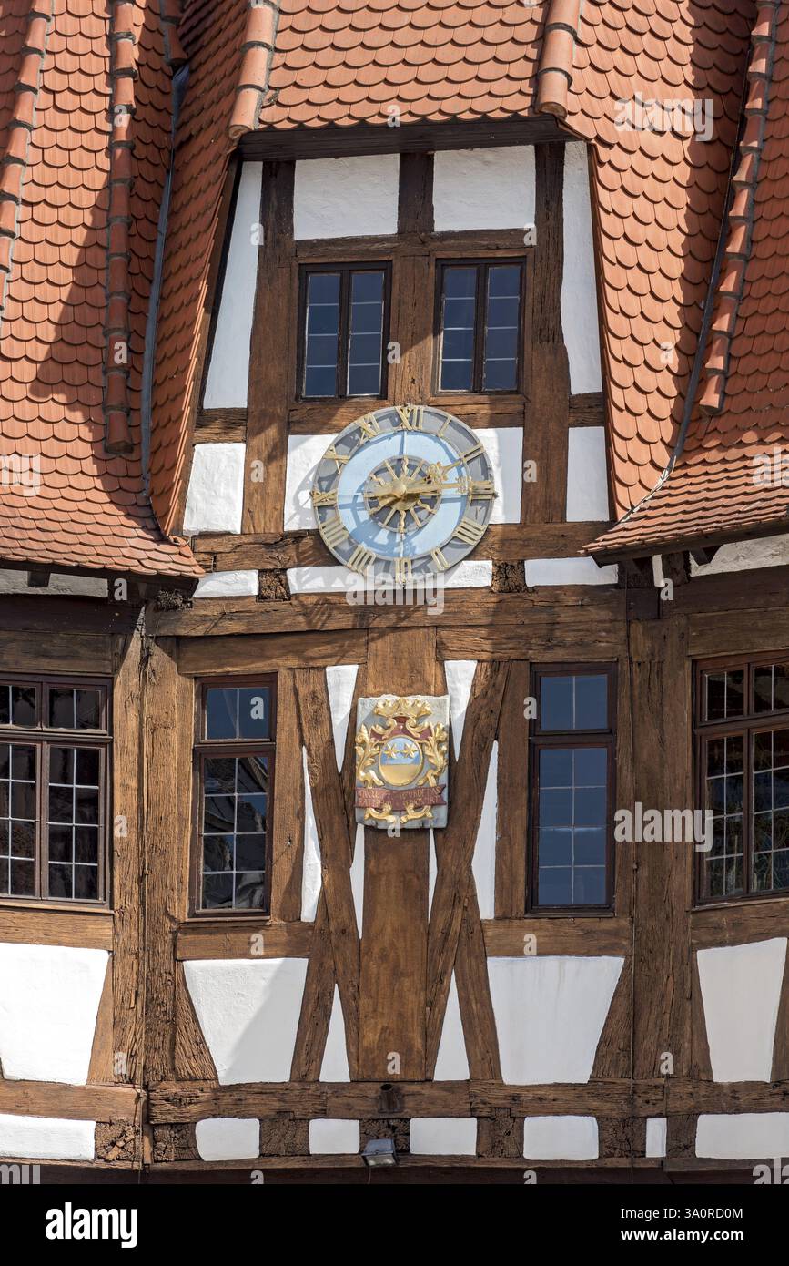 Clock and town coat of arms on facade between beams of half-timbering ...