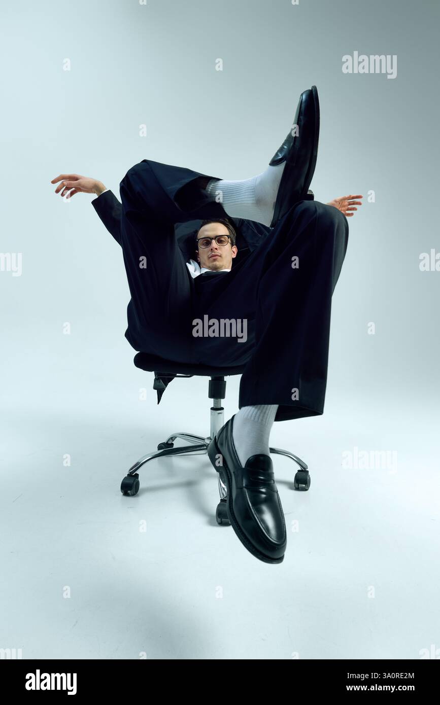Confident entrepreneur reclining in surreal pose and exploring business ...