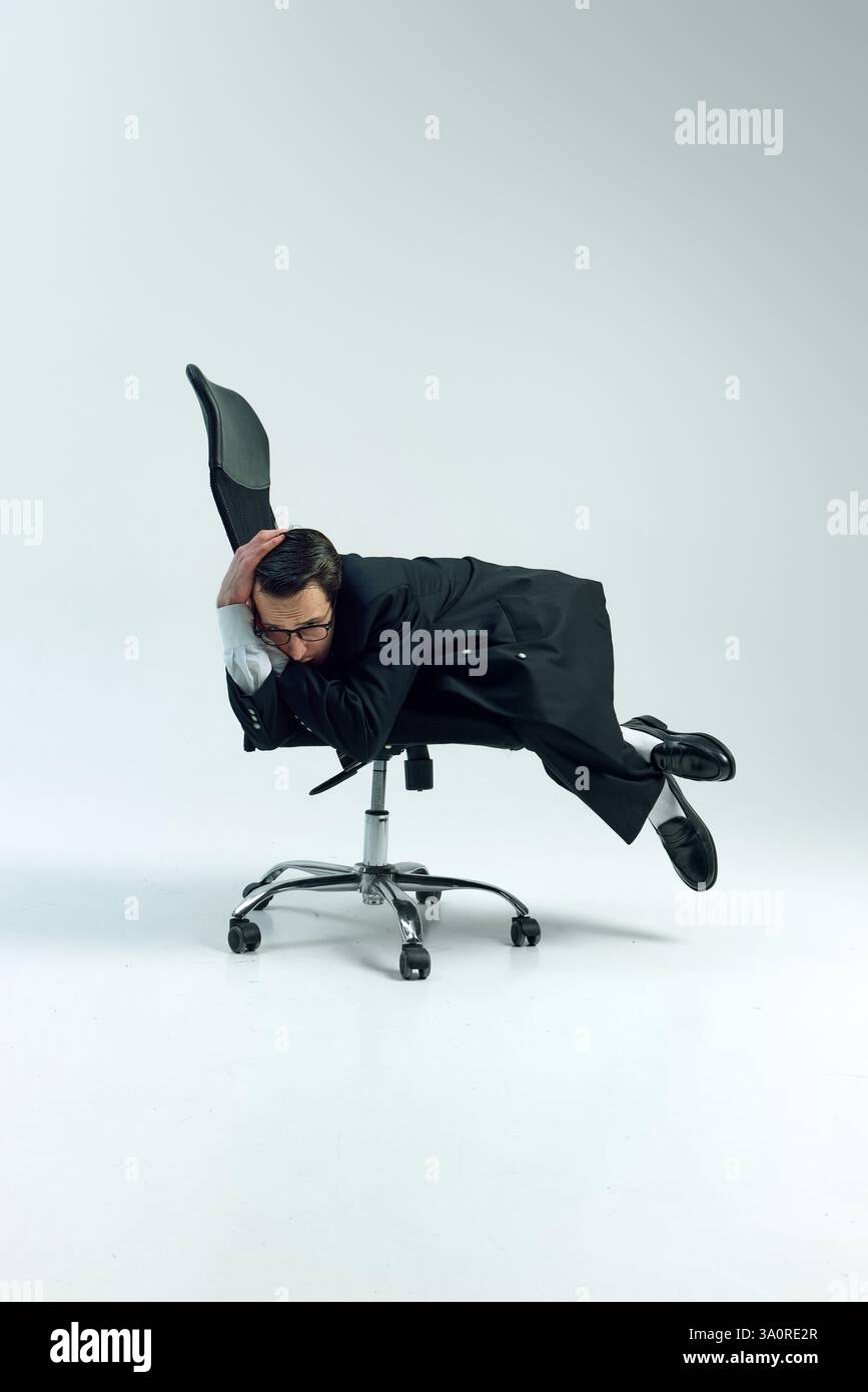 Man dressed formal attire, dynamically stretched and defying business ...