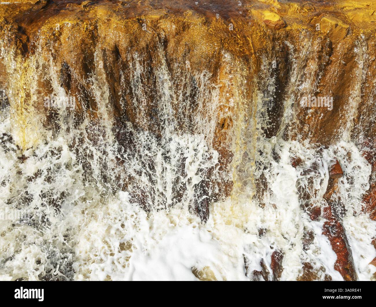 Detail of a waterfall in the Rio Tinto (Red river) with its orange-red ...