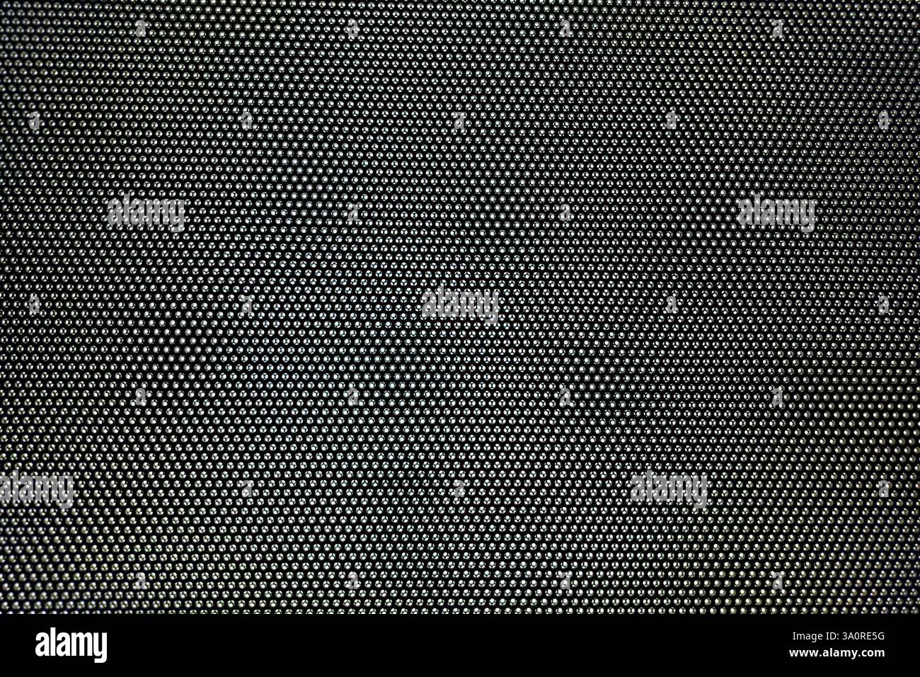 a metallic grid reflecting light, creating an illusion of waves and ...