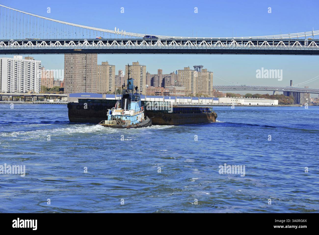 Manhattan Bridge, Suspension bridge over a body of water with city ...