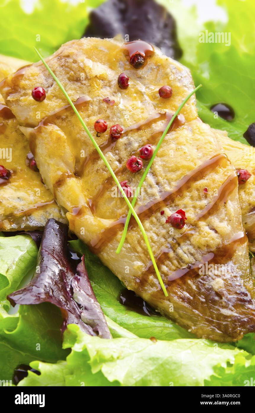 Roasted one fish with balsamic cream ones Stock Photo - Alamy