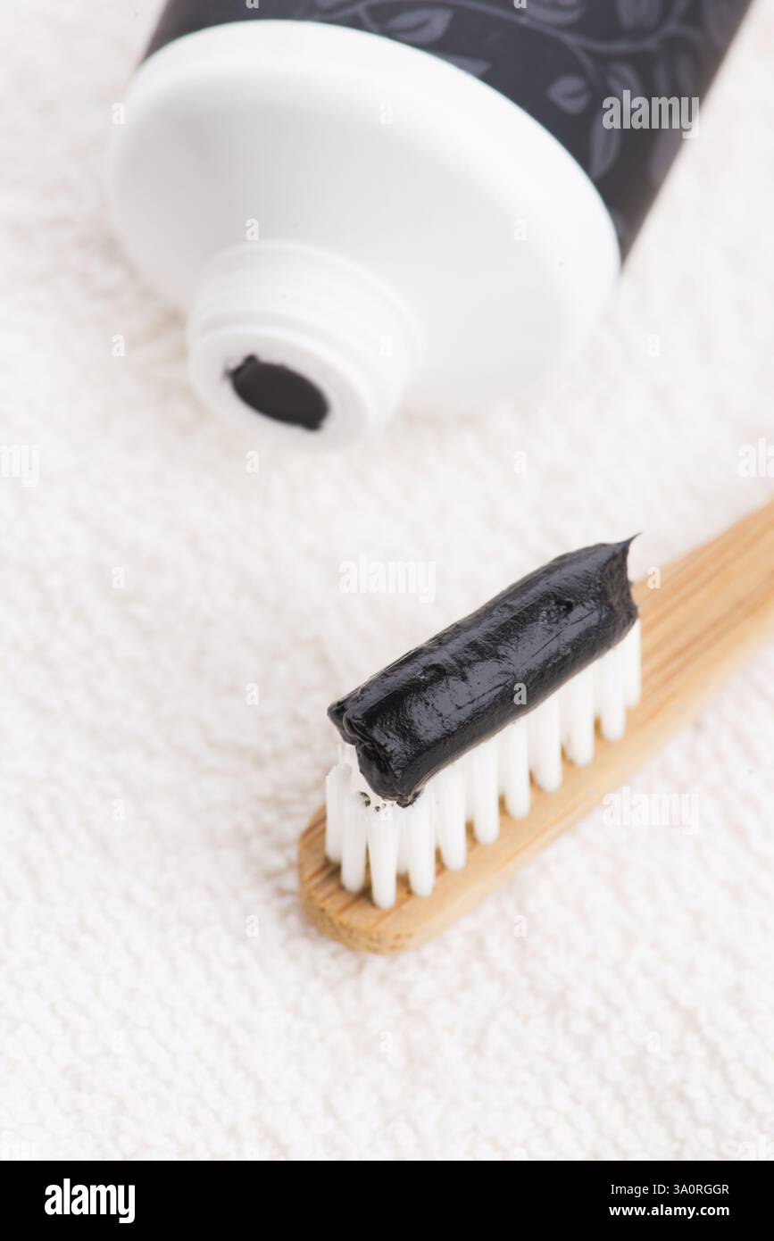 Toothbrush with black charcoal toothpaste Stock Photo - Alamy