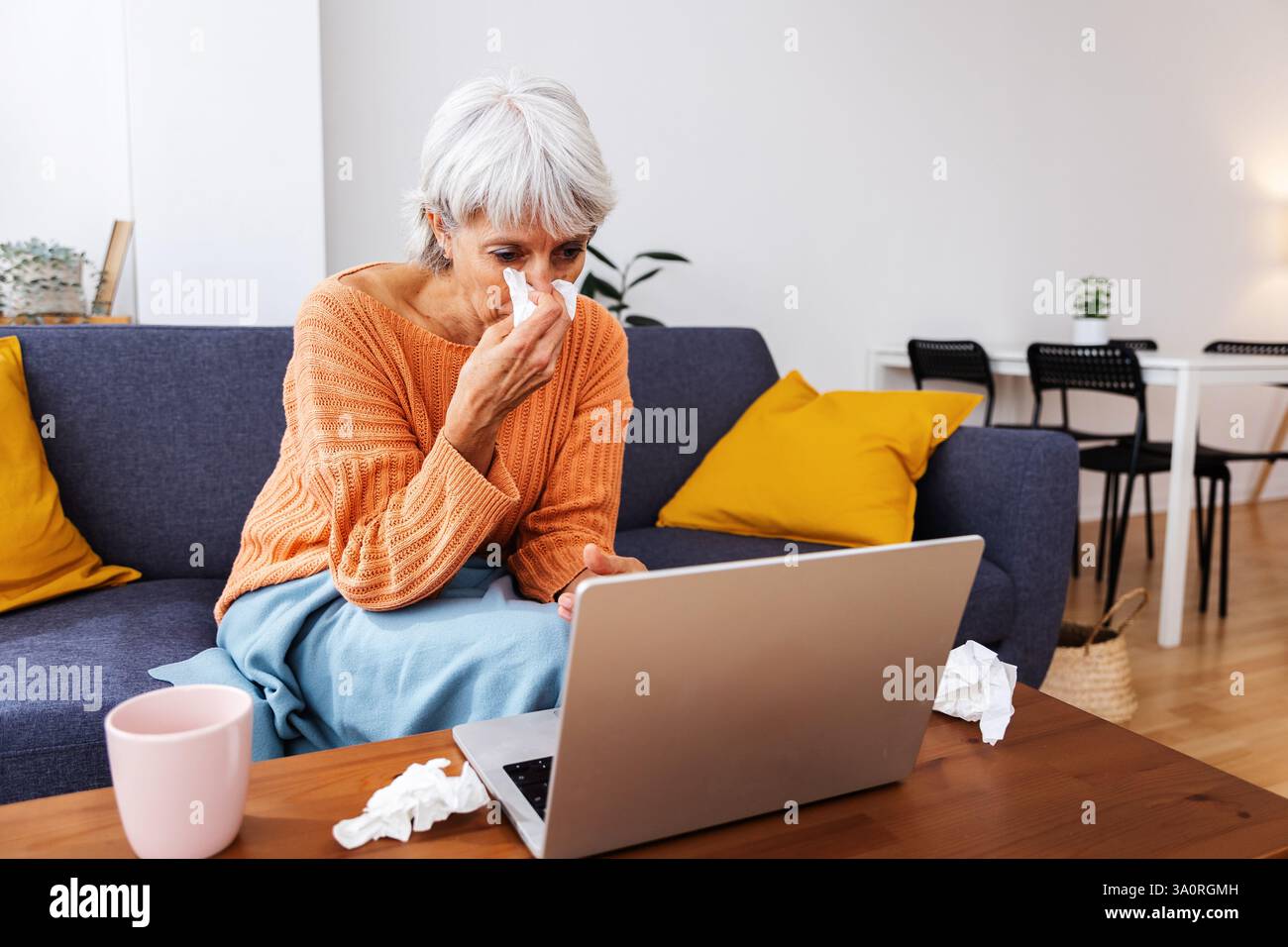 Senior woman talking with doctor through virtual meeting on video call ...