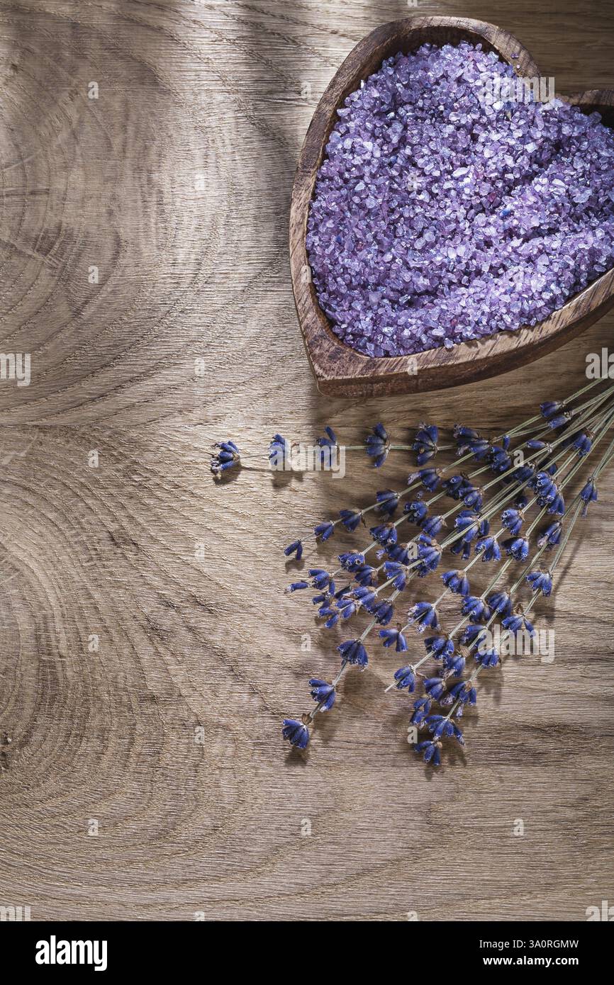 Bowl with sea salt bunch of dry lavender on wood board spa treatment ...