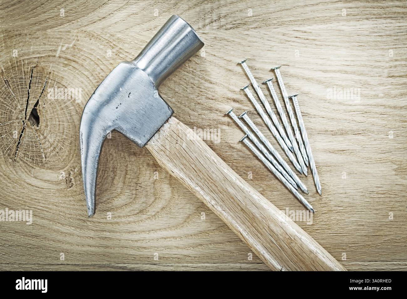 Claw hammer construction nails on wooden board top view building ...