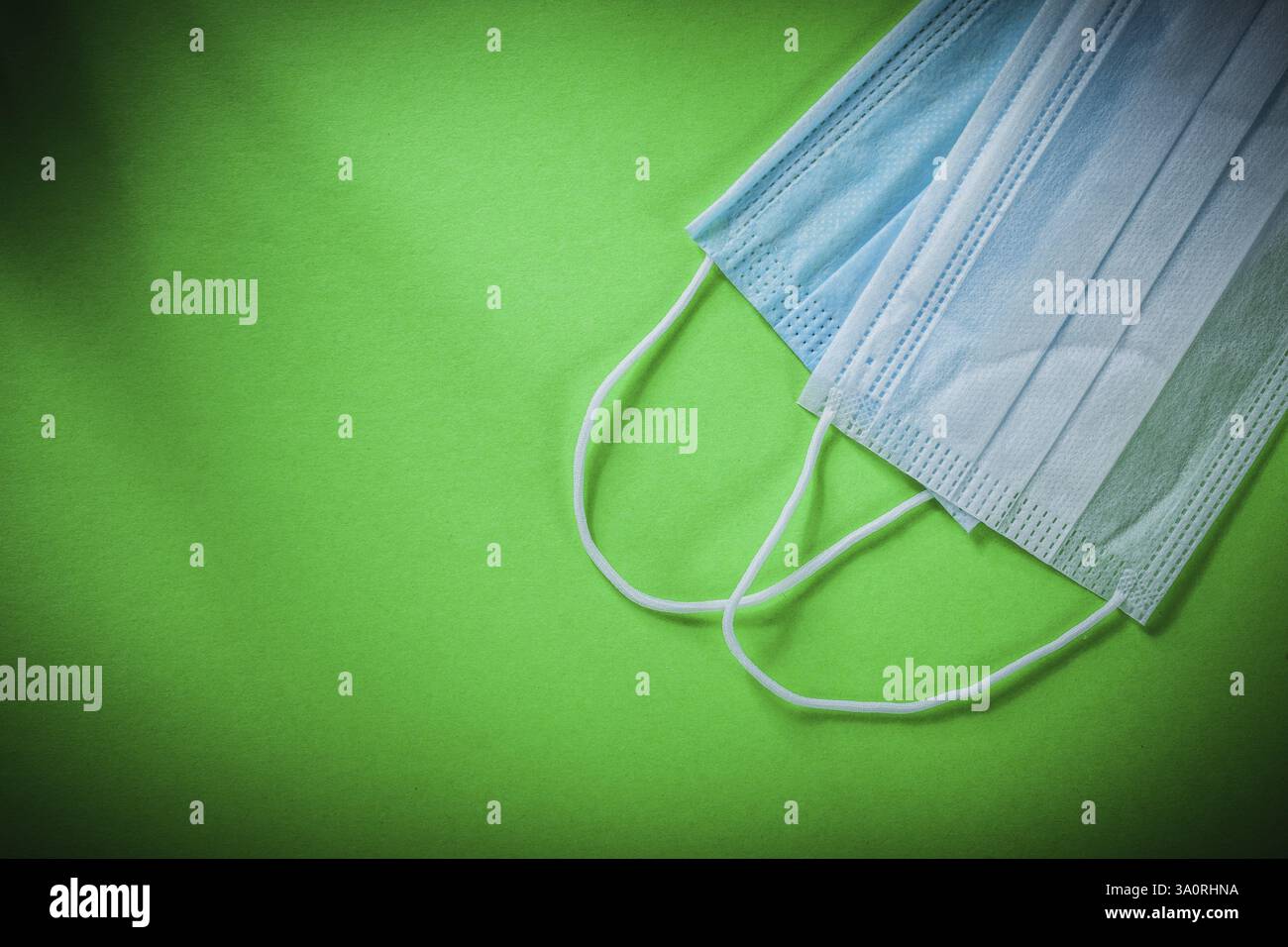 Disposable sterile surgical mask on green background Stock Photo - Alamy