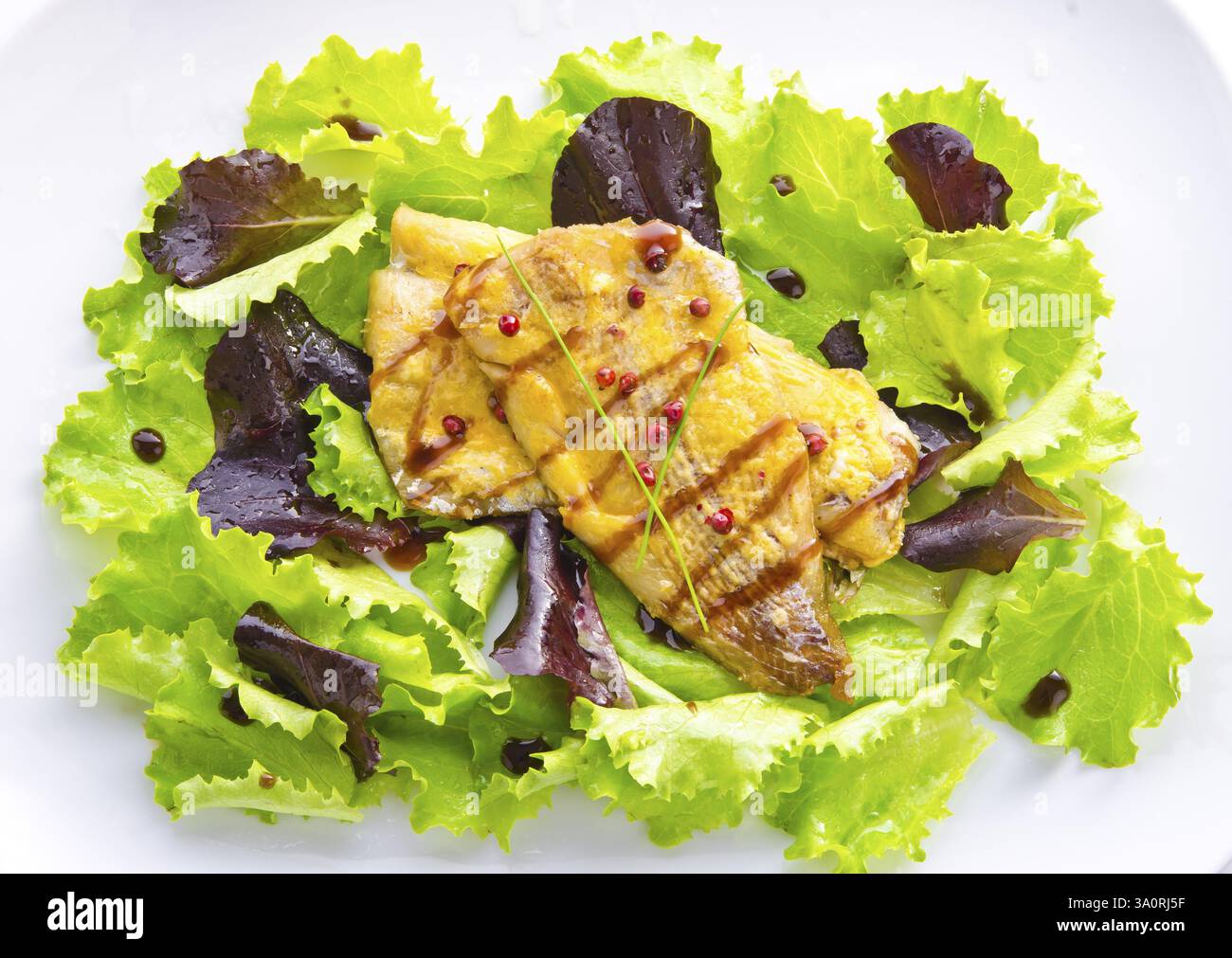 Roasted one fish with balsamic cream ones Stock Photo - Alamy