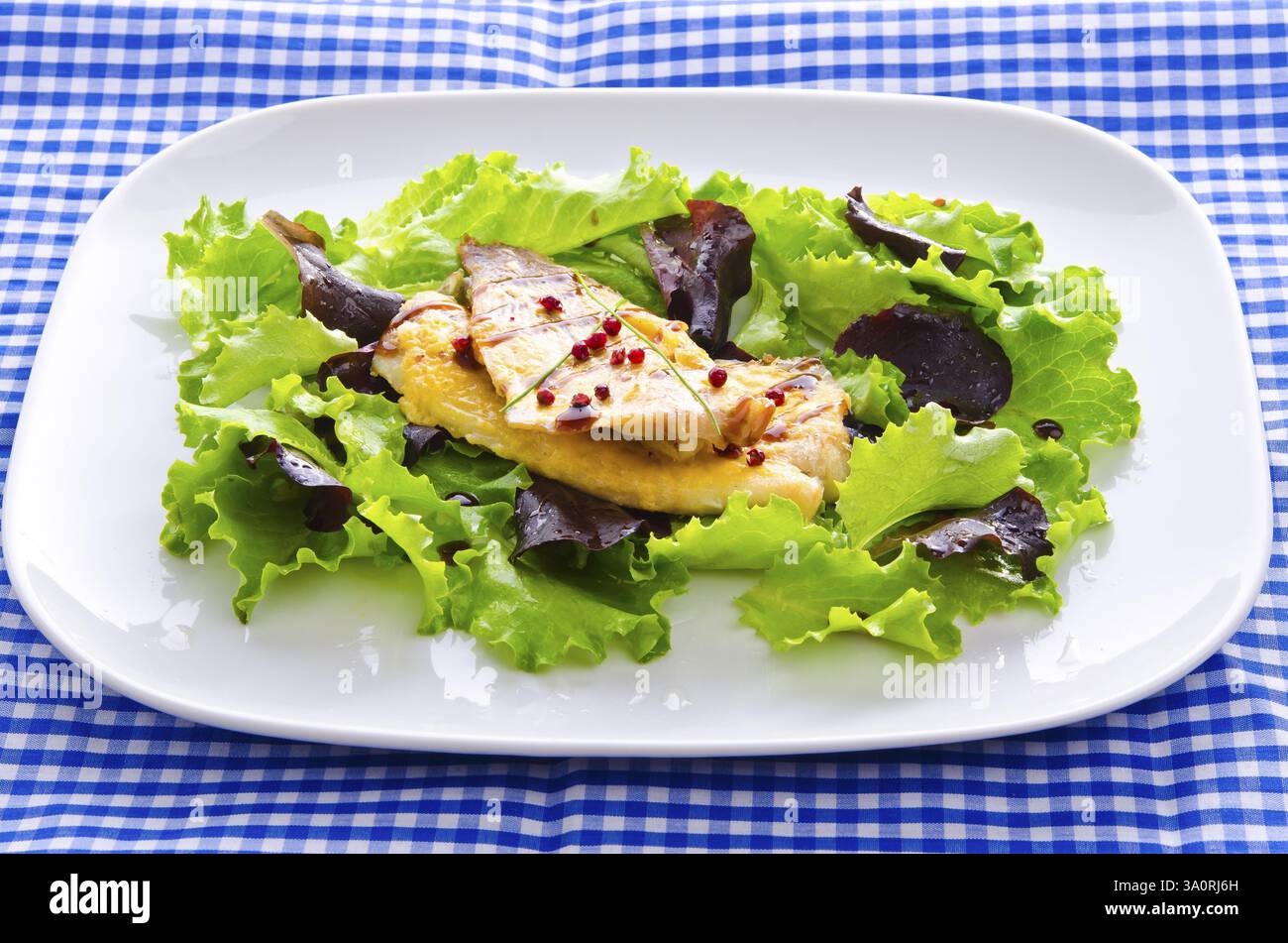 Roasted one fish with balsamic cream ones Stock Photo - Alamy
