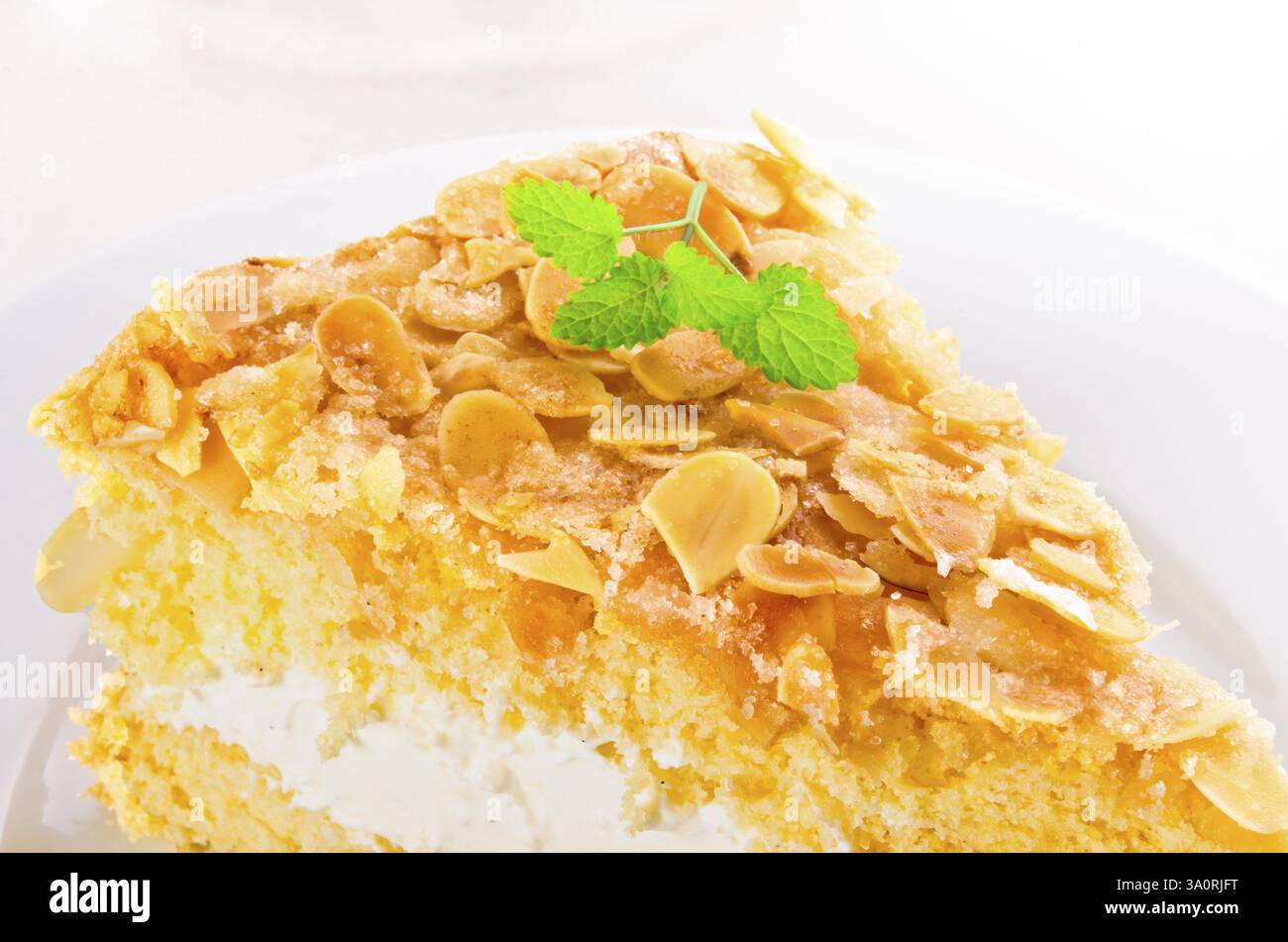 Flat cake with an almond and sugar coating and a custard or cream ...