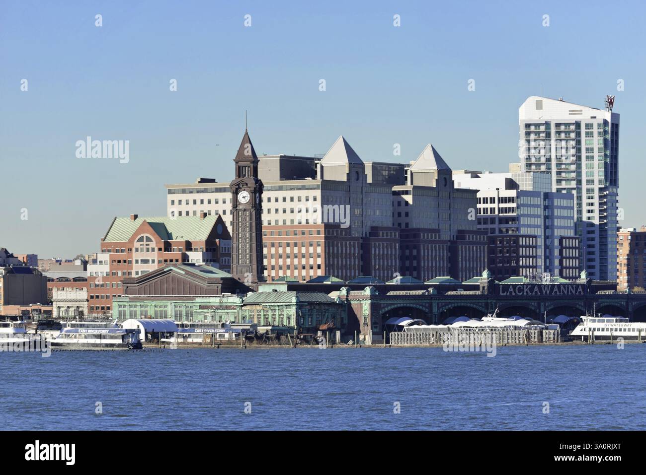 Historic buildings and modern clock tower on a waterfront along the ...