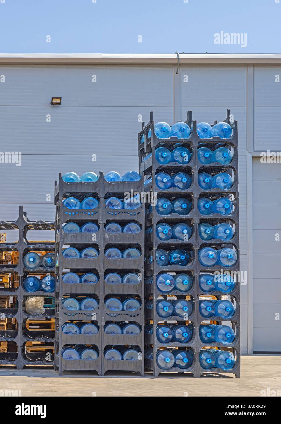 Large Stack of Blue Water Cooler Empty Bottles Storage Stock Photo - Alamy